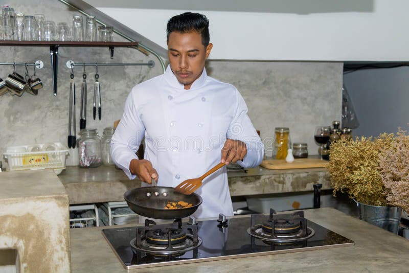 Young Asian Chef is Cooking in the Kitchen Stock Photo - Image of male ...