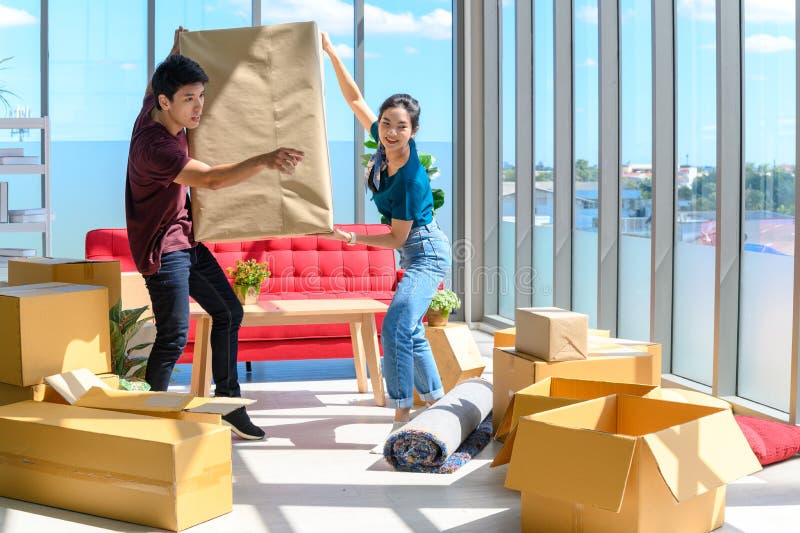 Young Asian Couple Smiling And Enjoy When They Carrying Big Cardboard