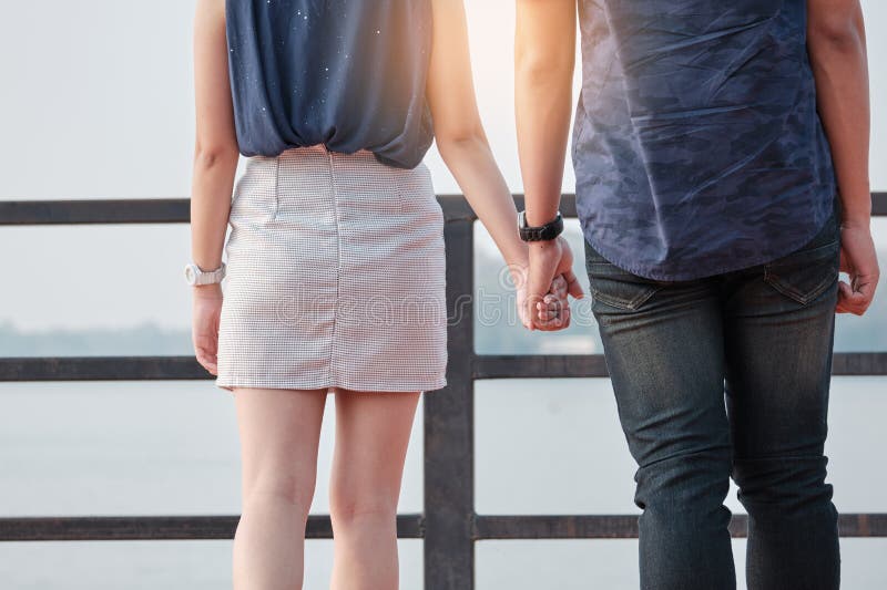 Young Asian Couple Standing And Holding Hand With Pure Love Stock Image