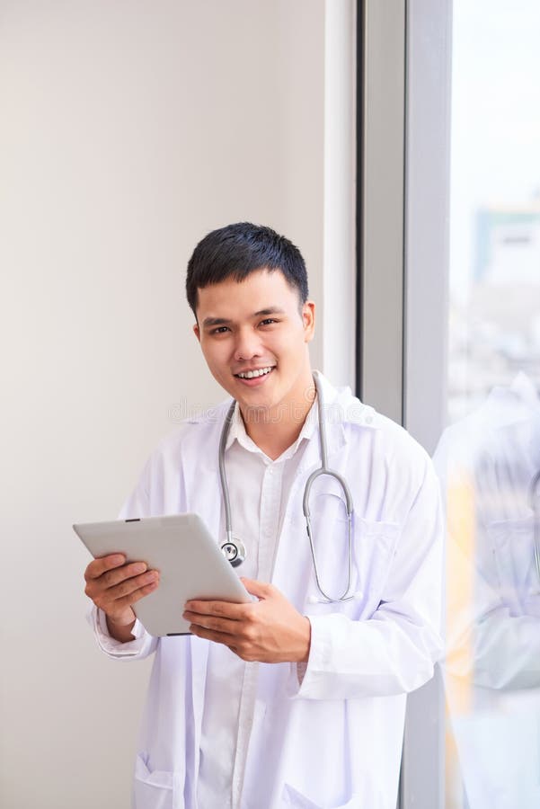 Young Asian Doctor Using His Tablet Computer at Work Stock Image ...