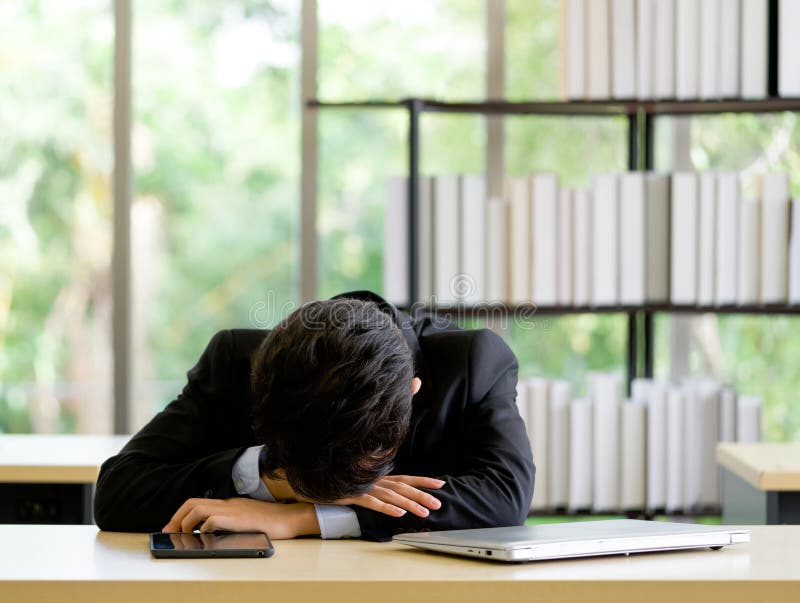 Young Asian Employee Take a Nap in the Office on a Table with Tablet ...