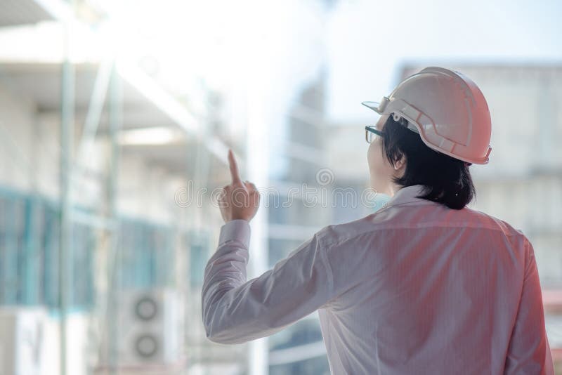 Asian Engineer Pointing at Construction Site Stock Photo - Image of ...