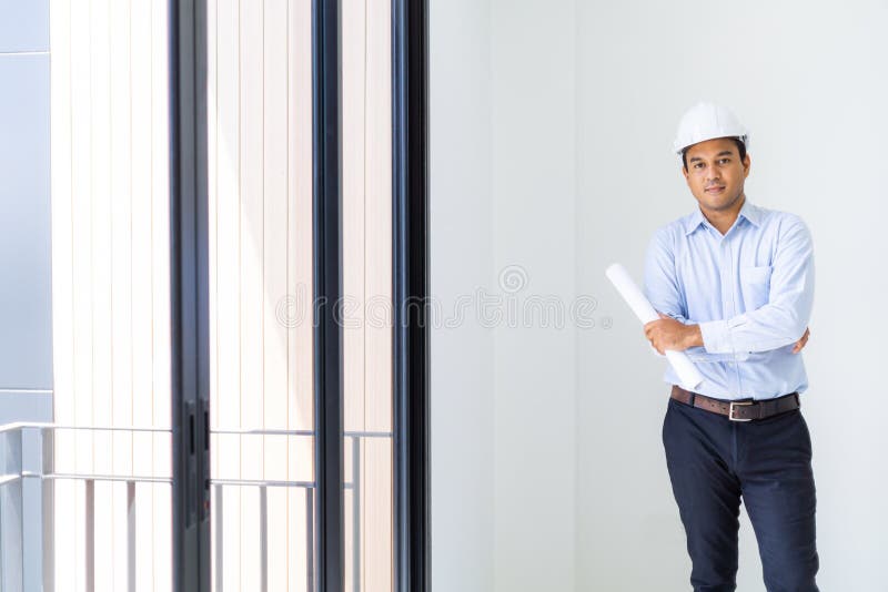 Young Asian Engineer or Architects Holding Layout Plan of Building ...