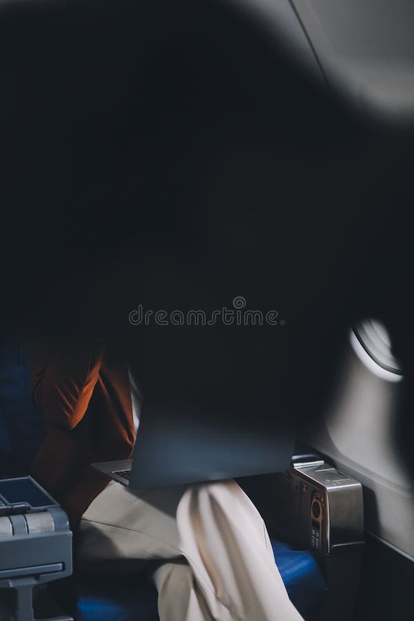 .Young Asian Executive Excels in First Class, Multitasking with Digital ...