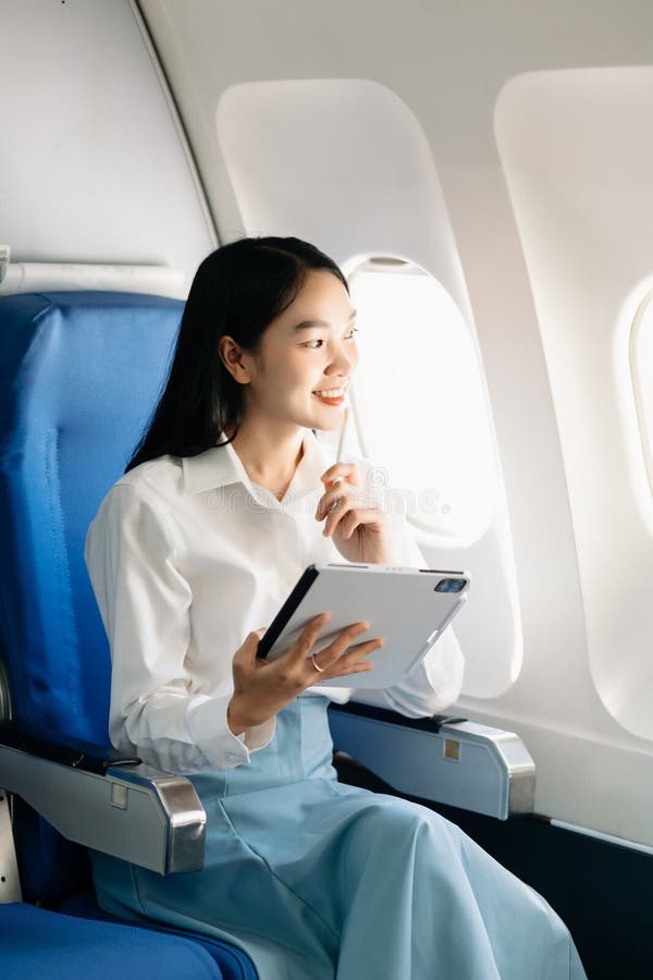 Young Asian Executive Excels in First Class, Multitasking with Digital ...