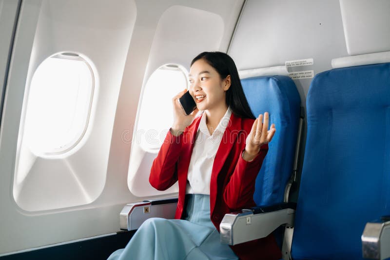 Young Asian Executive Excels in First Class, Multitasking with Digital ...