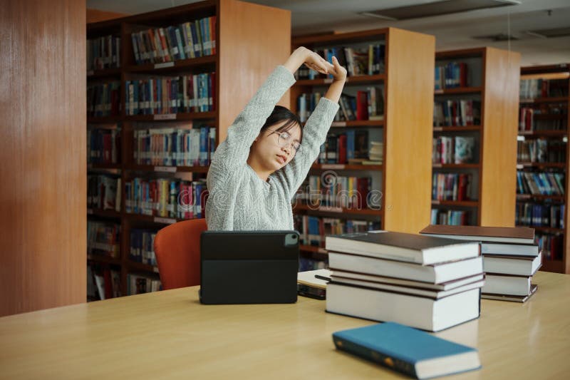 Young Asian Female College Student Stretching Hands, Relaxing at Her ...
