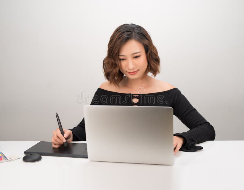 Young Asian Female Designer Using Graphics Tablet while Working with ...