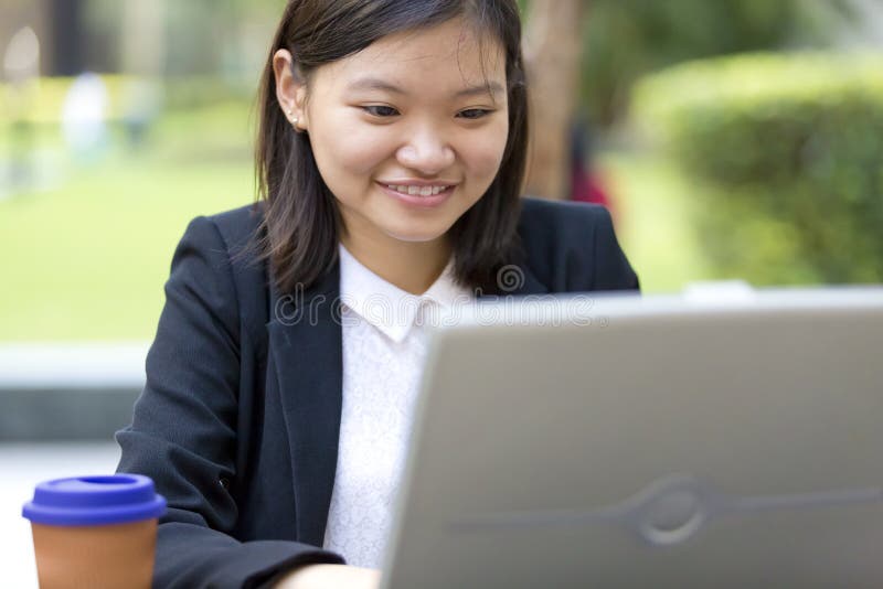 Young Asian Female Executive Drinking Coffee and Using Laptop PC Stock ...