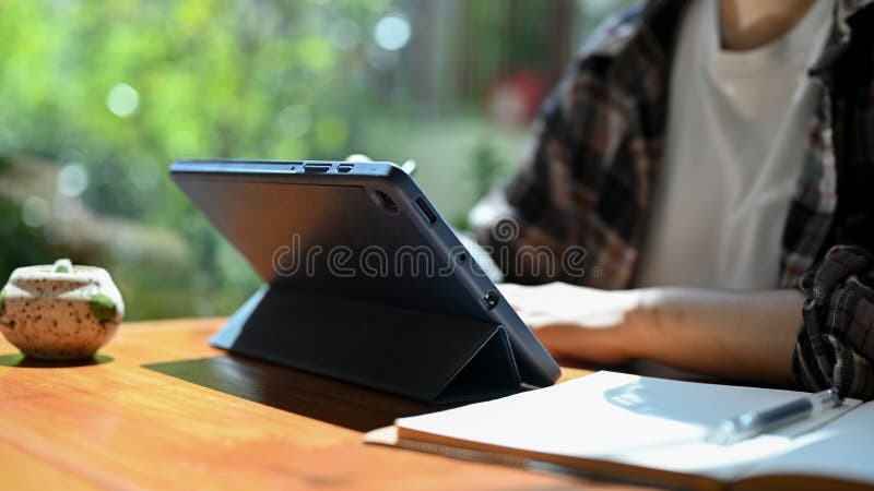 Young Asian Female Freelancer Remote Working at the Cafe, Using Tablet ...