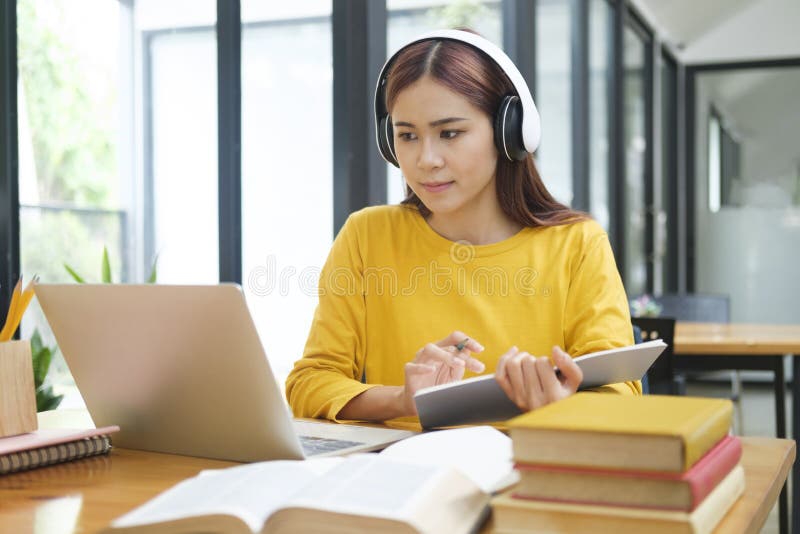 Woman Learning Online Using Laptop and Writing Notes. Stock Image ...