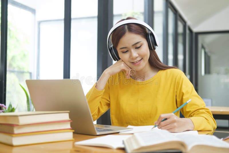 Woman Learning Online Using Laptop and Writing Notes. Stock Image ...