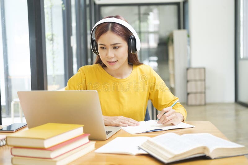 Woman Learning Online Using Laptop and Writing Notes. Stock Image ...