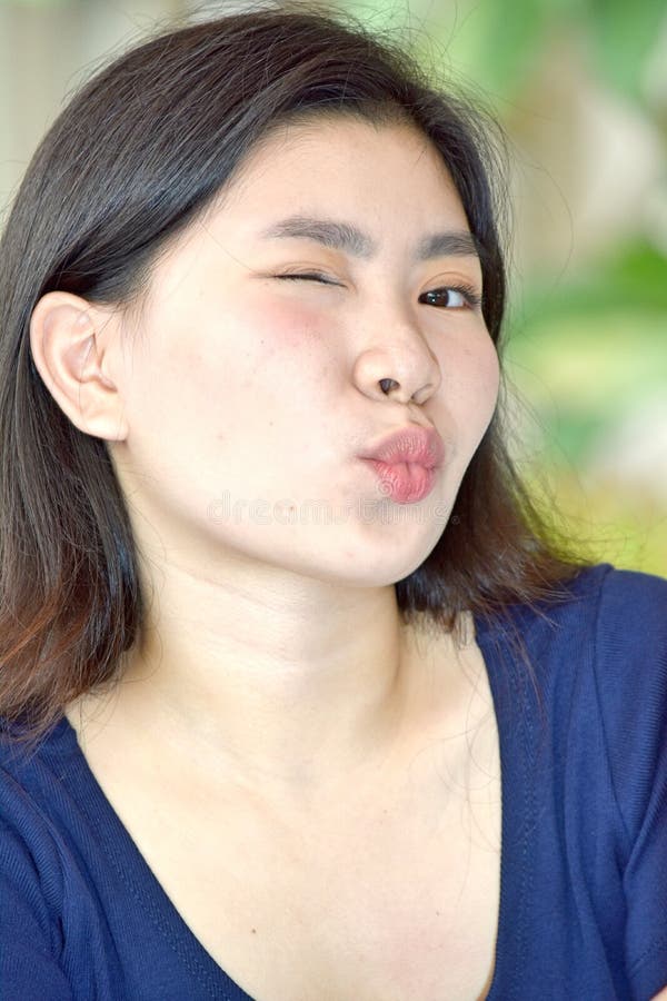 A Young Asian Female Winking Stock Image - Image of blink, wink: 262303989