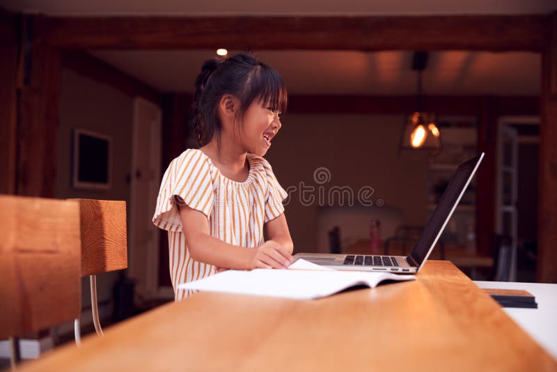 Young Asian Girl Home Schooling Working at Table Using Laptop Stock ...