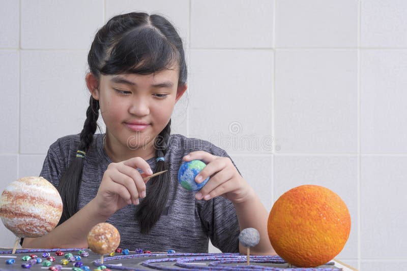 Asian Girl Showing Her Homemade Solar System Model for Science Homework ... Asian Girl Showing Her Homemade Solar System Model for Science Homework ...