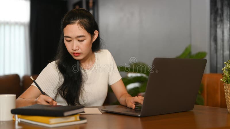 Young Asian Lady Study Online on Laptop and Writing Important ...