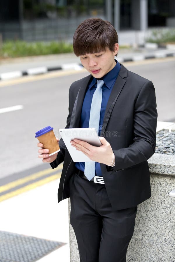 Young Asian Male Business Executive Using Tablet PC Stock Photo - Image ...