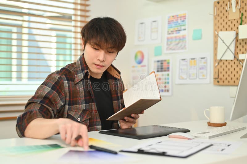 Young Asian Male Designer Planning Mobile App Development Prototype ...