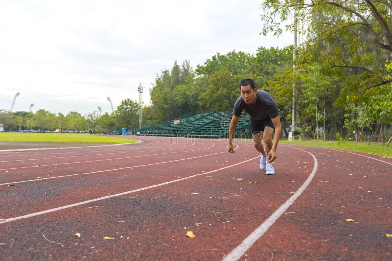 Asian Man Athlete Running and Training on the Running Track. Stock ...