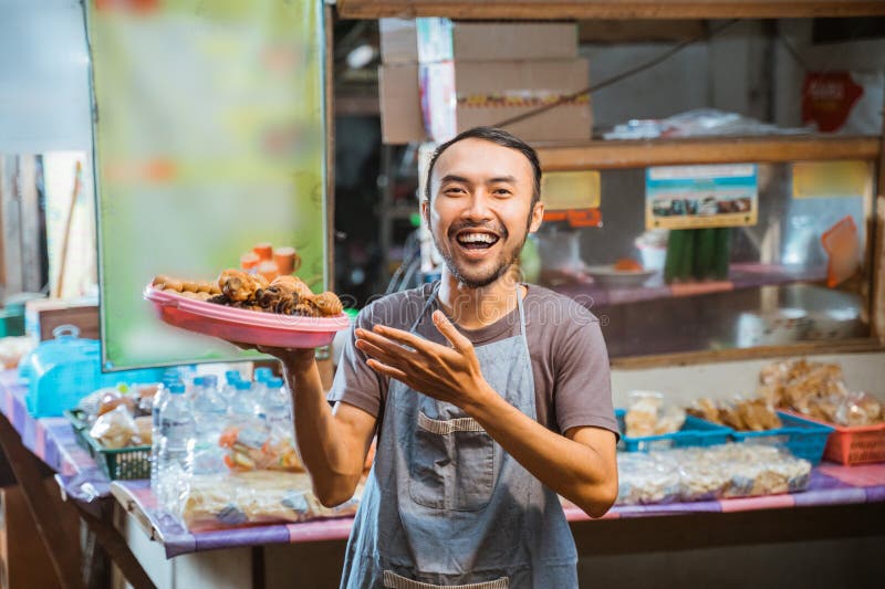 Young Asian Man Carrying of Snacks with an Offering Gesture Stock Image ...
