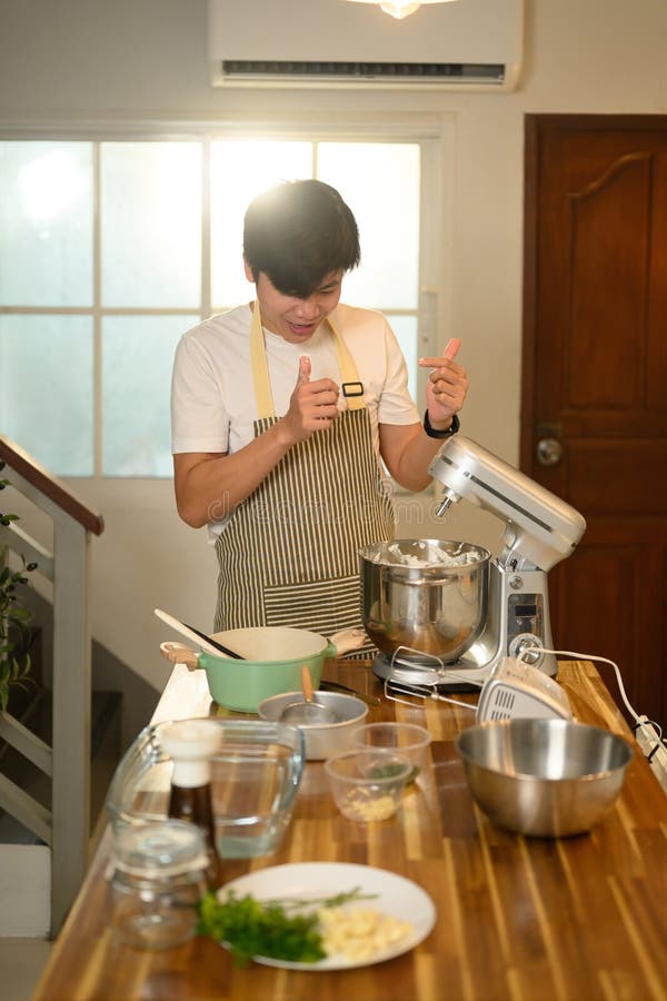 Young Asian Man Checks the Texture of Whipped Cream during Home Baking Stock Photo - Image of ...
