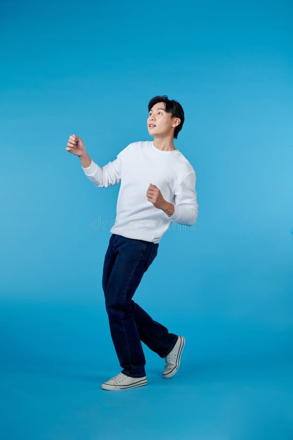 Young Asian Man Dancing Isolated on Blue Background Stock Photo - Image ...