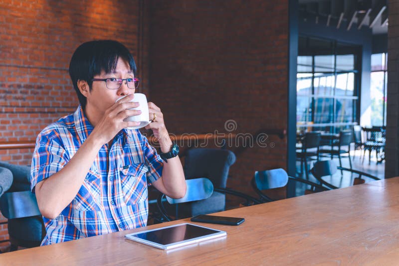 Young Asian Man Drinking Coffee in Cafe Stock Image - Image of ...