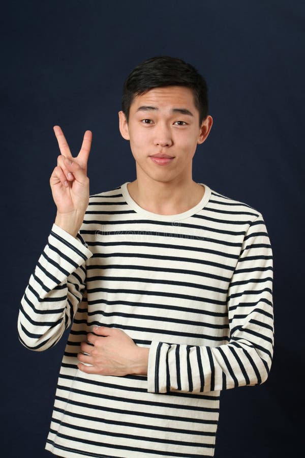Young Asian Man Giving the Victory Sign Stock Photo - Image of camera ...