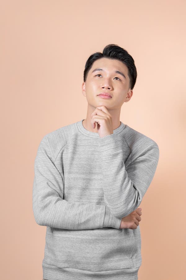 Young Asian Man with Hand on Chin Thinking about Question, Pensive ...