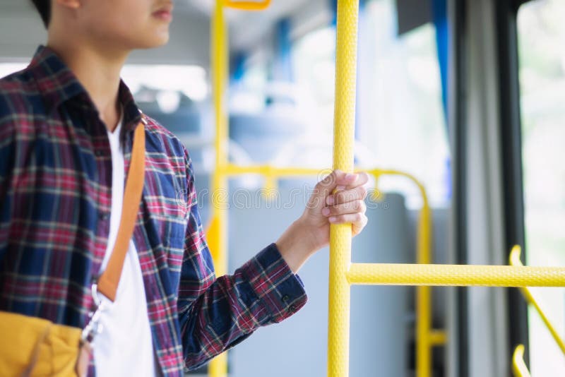 Young Asian Man Holding Handle on the Public Bus Stock Image - Image of ...