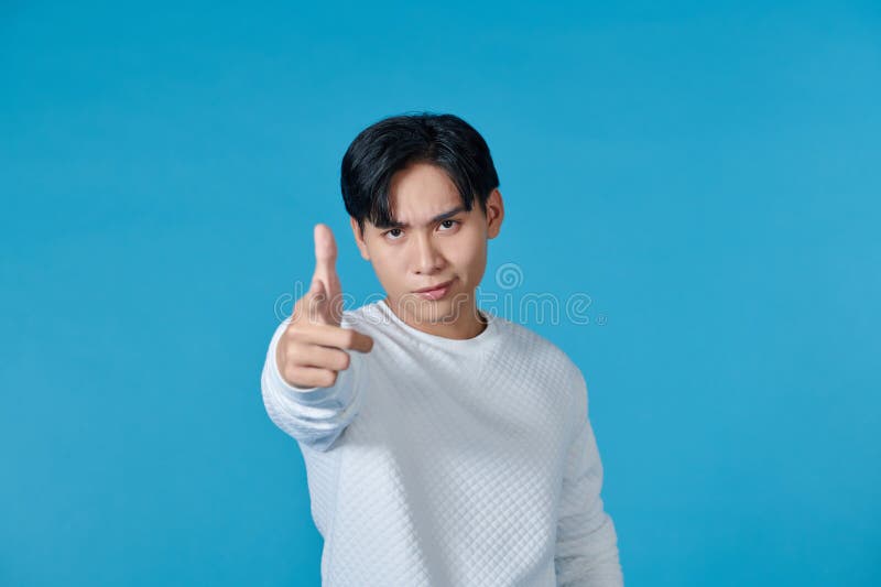 A Friendly Asian Man Points To the Camera while Smiling. Endorsing ...