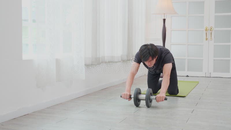 Young Asian Man Practicing Workout Exercise with Roller for Muscle ...