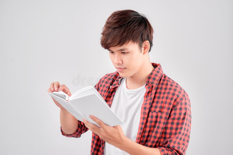Young Asian Man Reading a Book, Smiling Expression Stock Photo - Image ...
