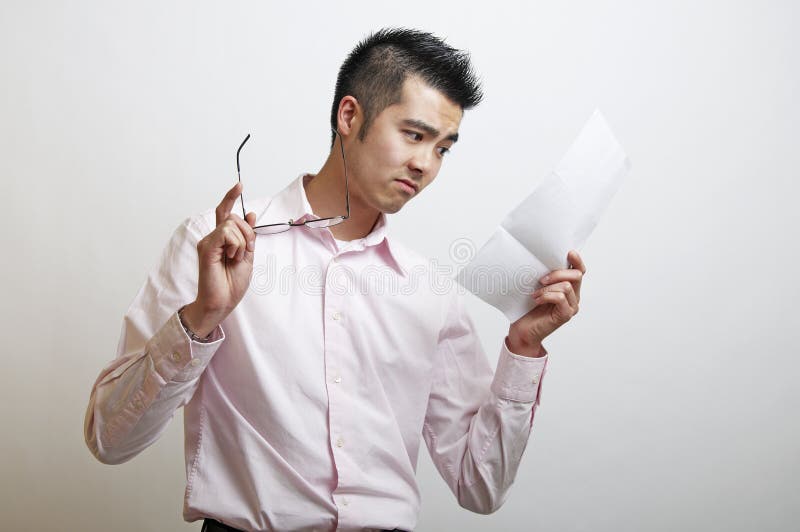 A Young Asian Man Reading a Letter Stock Image - Image of office ...