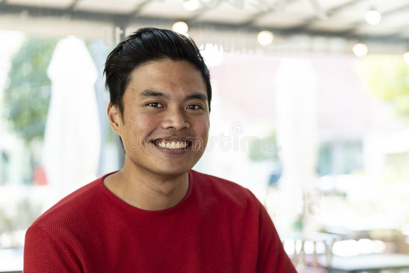 Young Asian Man Smiling on Camera Indoor - Focus on Face Stock Photo ...