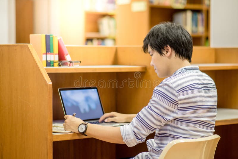 Young Asian Man University Student Using Laptop in Library Stock Photo ...