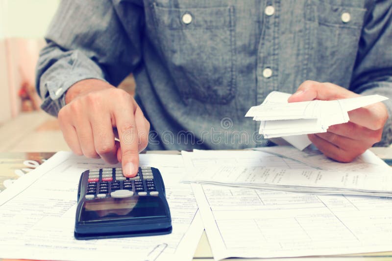 Young Asian Man Using Calculator Calculating Bills Home Stock Photos ...