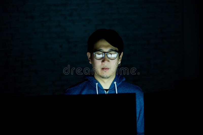 Young Asian Man Using Computer in the Dark Room Stock Image - Image of ...