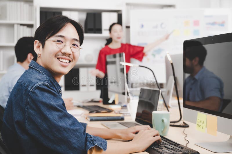 Young Asian Man Working on a Computer at Workplace Stock Photo - Image ...