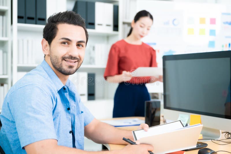 Young Asian Man Working on a Computer at Workplace Stock Photo - Image ...