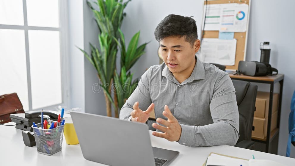 Young Asian Man Working on Laptop in Modern Office, Expressing Problem ...