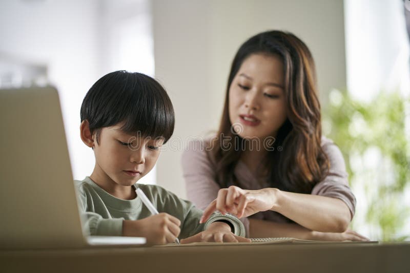 Young Asian Mother Helping Son with Homework Stock Photo - Image of ...
