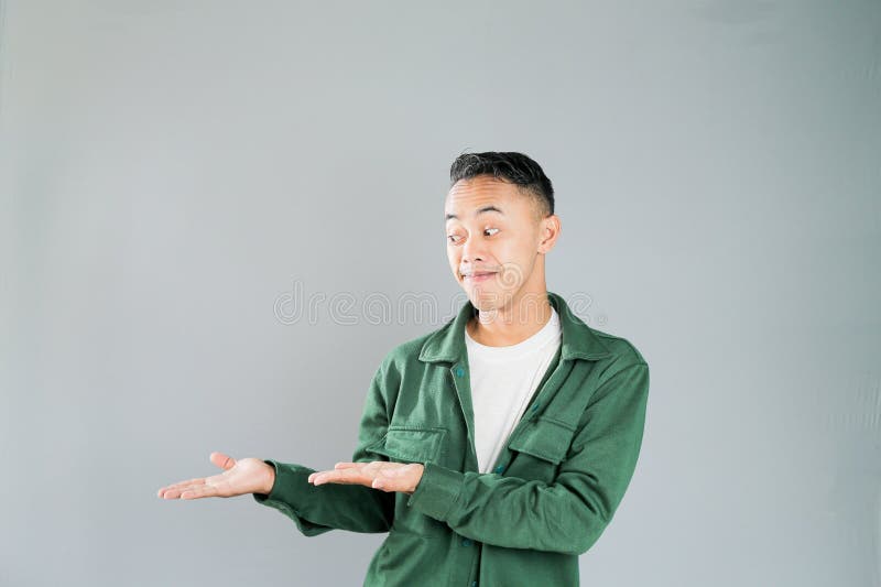 A Young Asian is Pointing Towards Something Stock Photo - Image of ...