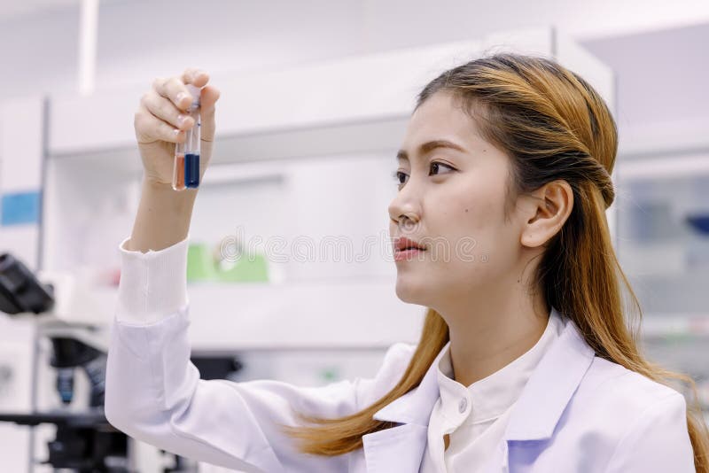 Young Asian Researcher Looking at the Flask in the Science Labor Stock ...