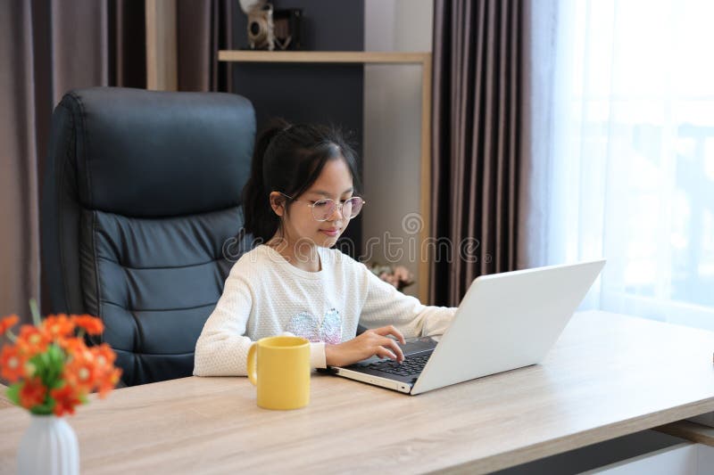 Young Asian Schoolgirl is Doing Her Class Homework Assignment at Home ...