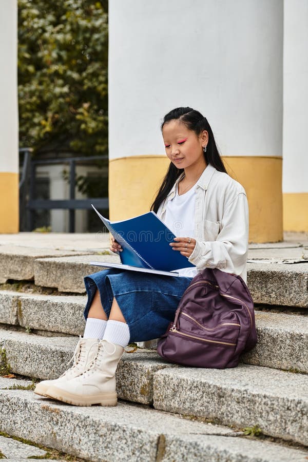 A Young Asian Student Sits on Stock Photo - Image of campus, backpack ...
