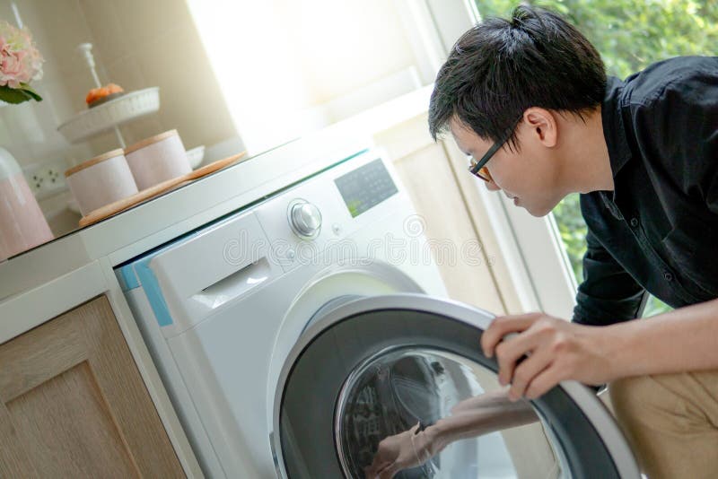 Asian Technician Looking into Washing Machine Stock Photo - Image of ...