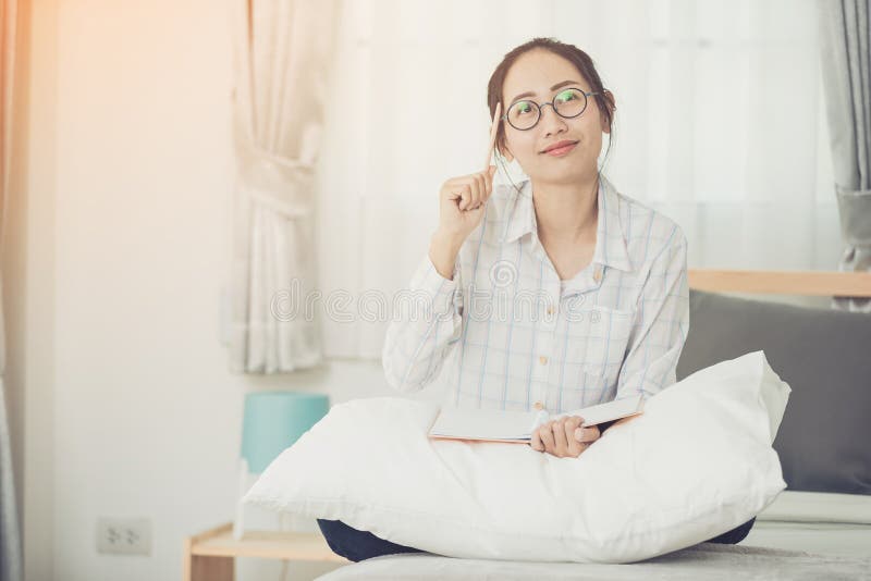 Young Asian Teenage Student Thinking on Bed . Stock Photo - Image of ...