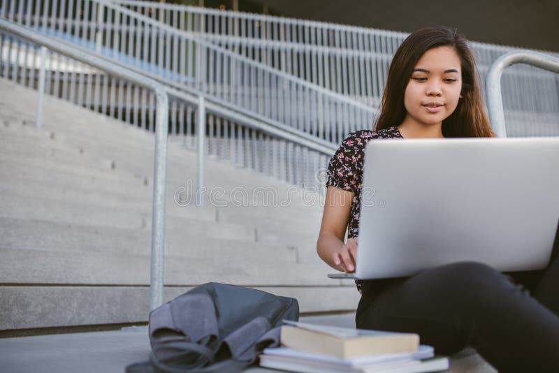 Young Asian University Student Using a Laptop on Campus Stock Image ...